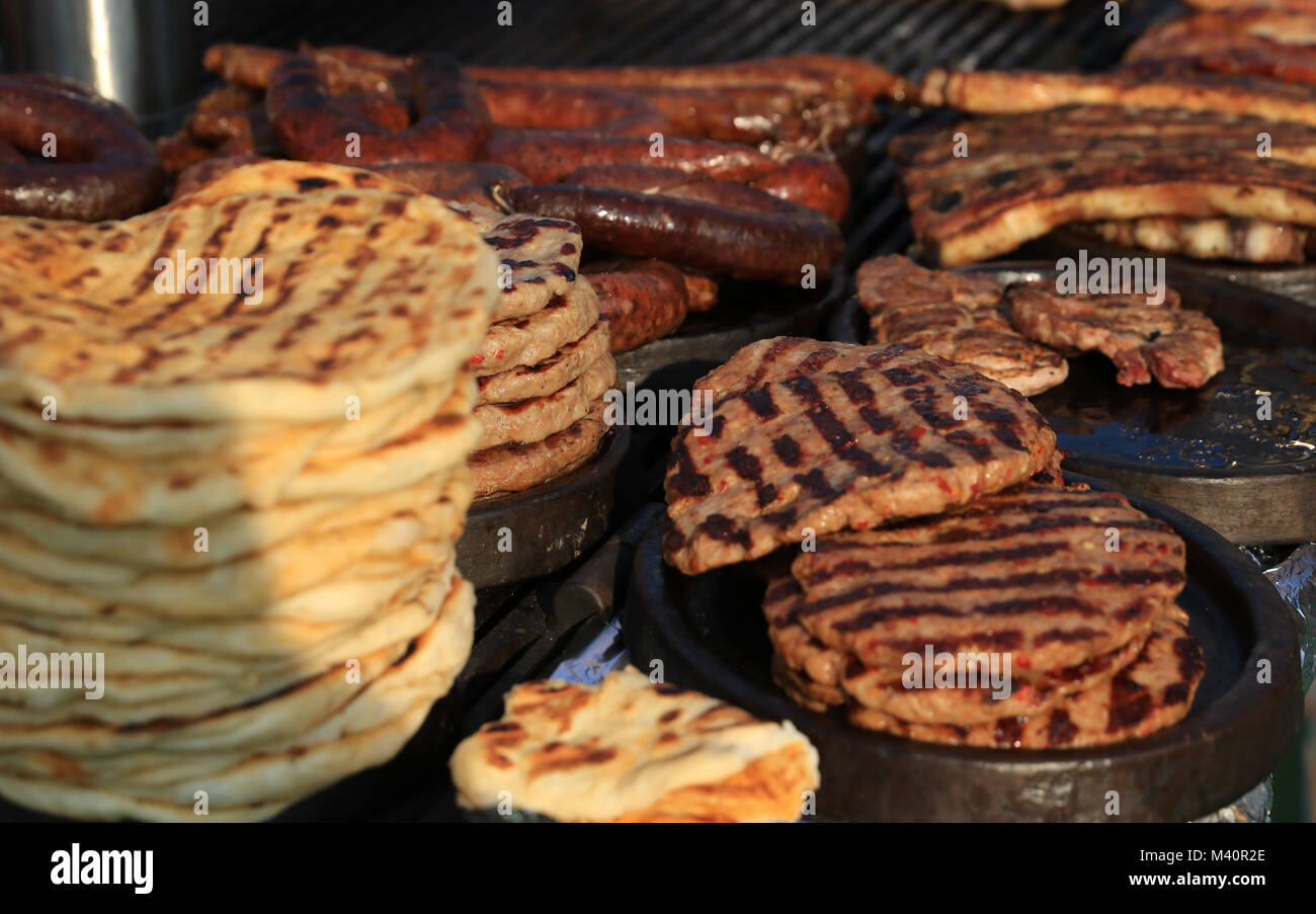 Grilled flatbread and pleskavica - grilled dish of spiced meat patty ...