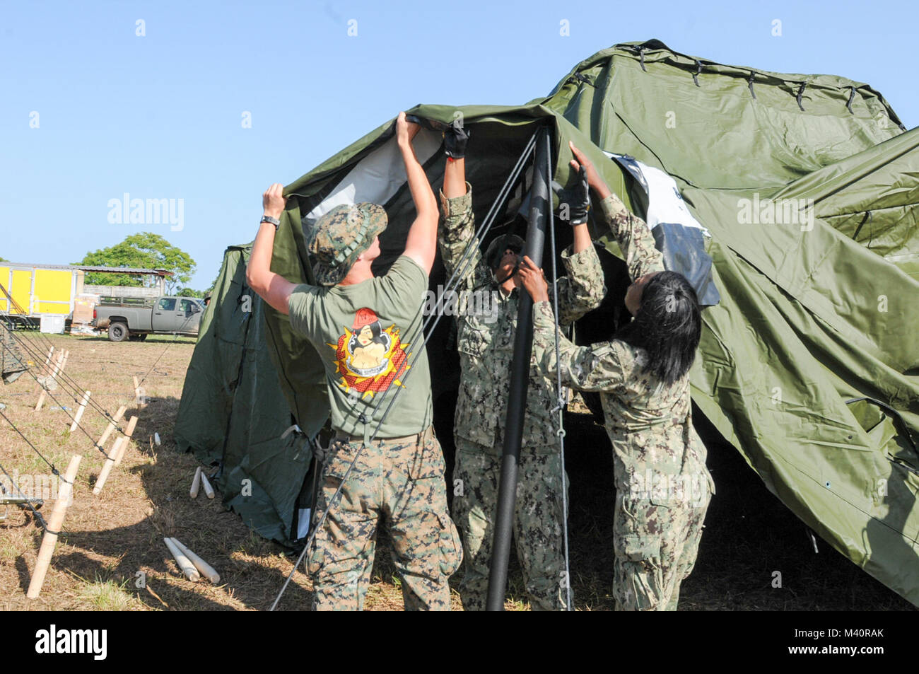 Sailors and Marines put up a shower tent for all of the personnel ...