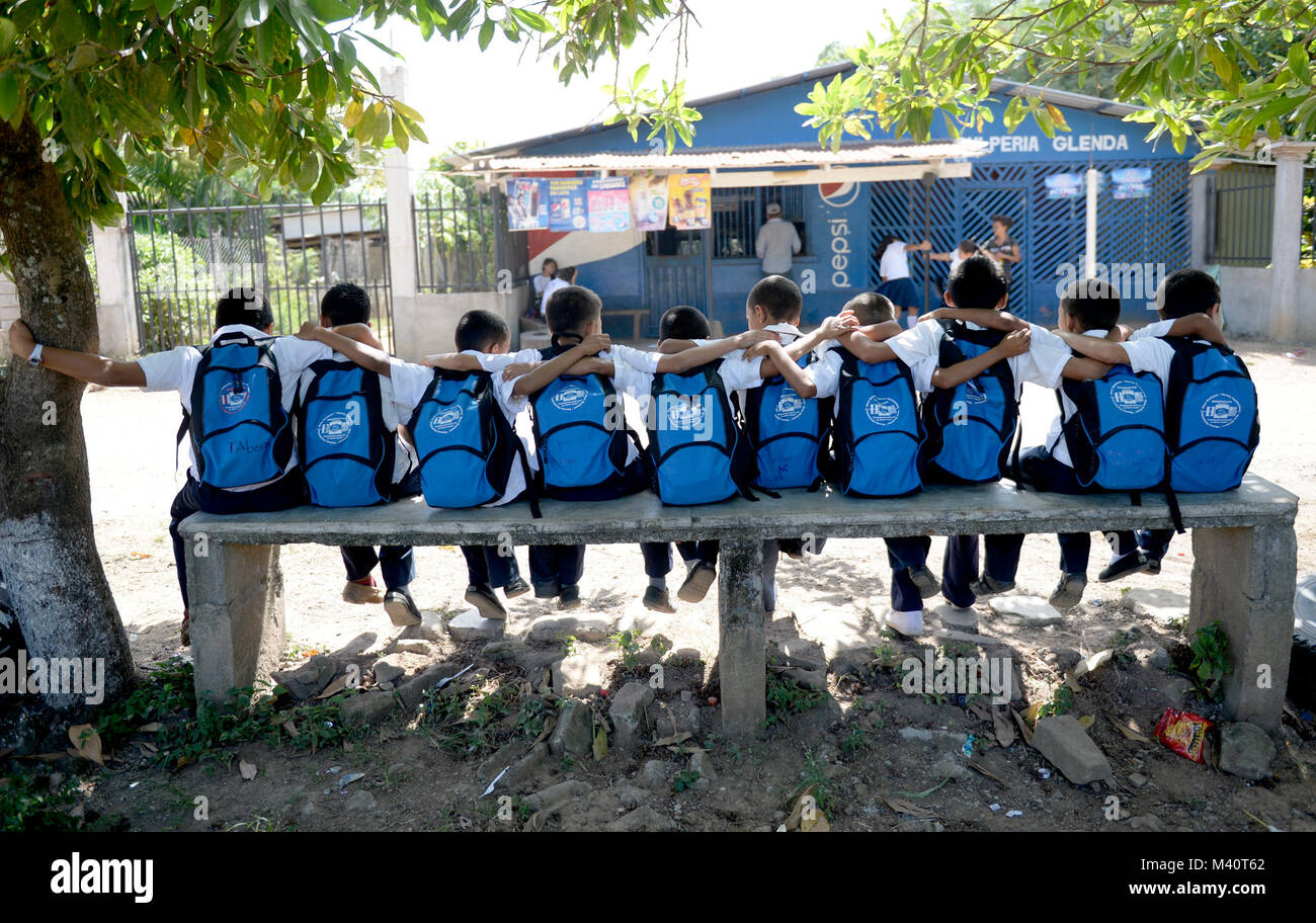 Local Honduran children show off their new backpacks outside Honduras ...