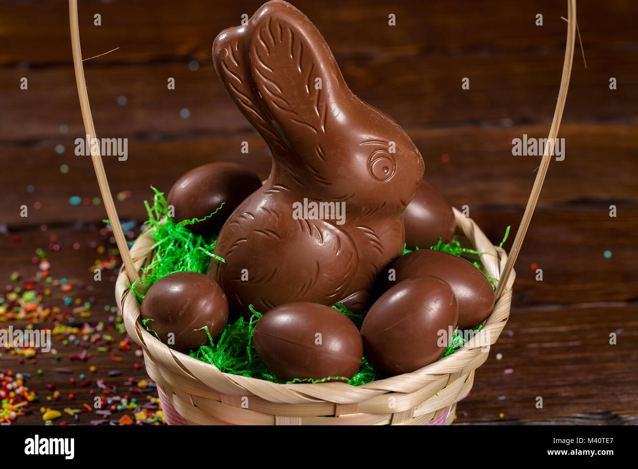 Beautiful Easter composition with chocolate bunny and eggs in a wicker ...