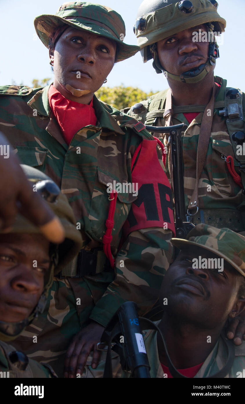 Military police with the Zambian Defense Force listen to a brief from ...
