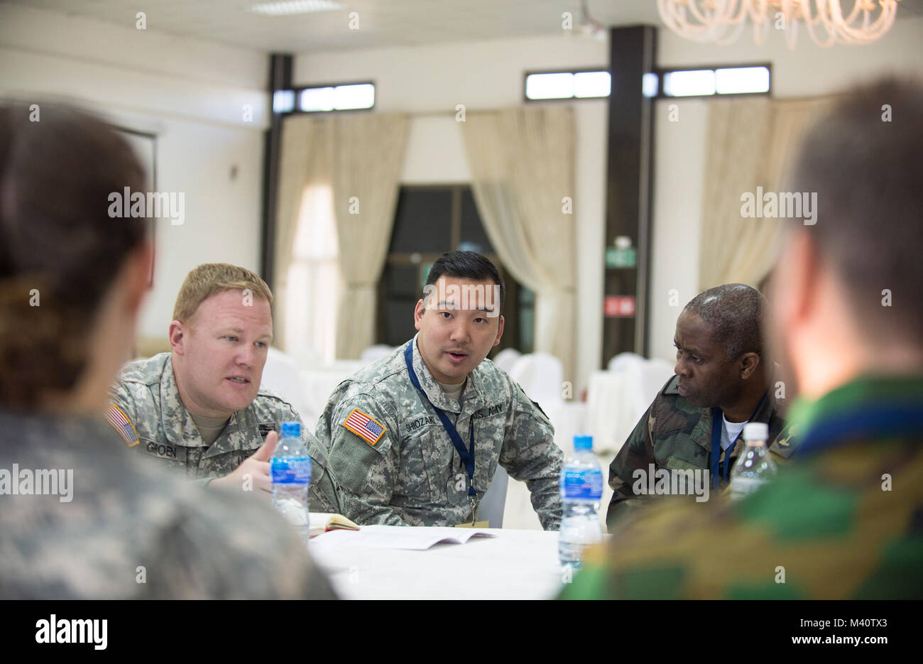 U.S. Army 1st Lt. Cade Shiuzaki (center), a military intelligence ...