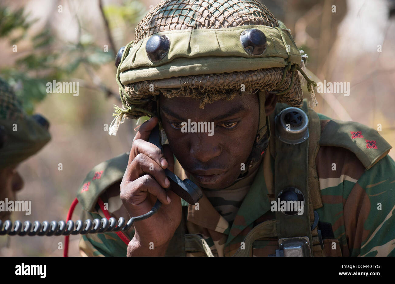A soldier with the Zambian Defense Force radios in to command post ...