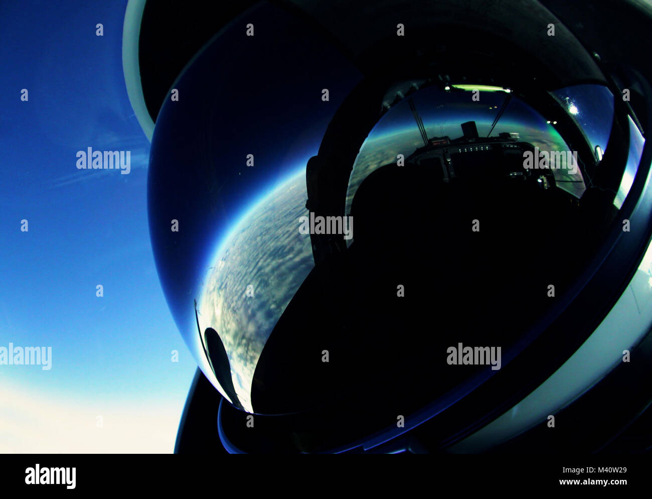 A reflection of the Earth's atmosphere is seen in the glass shield of a ...