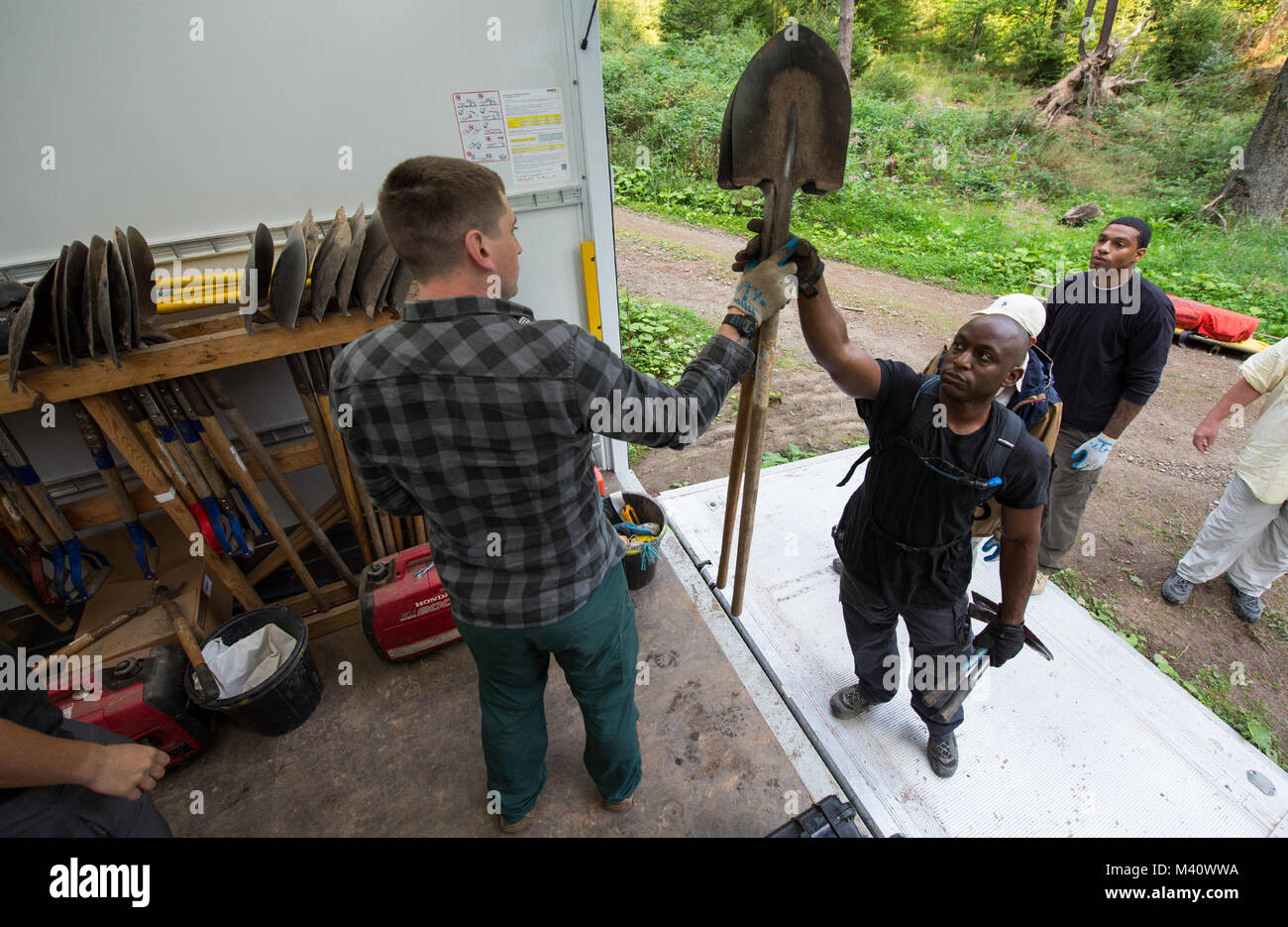 Members of a Defense POW/MIA Accounting Agency (DPAA) recovery team ...