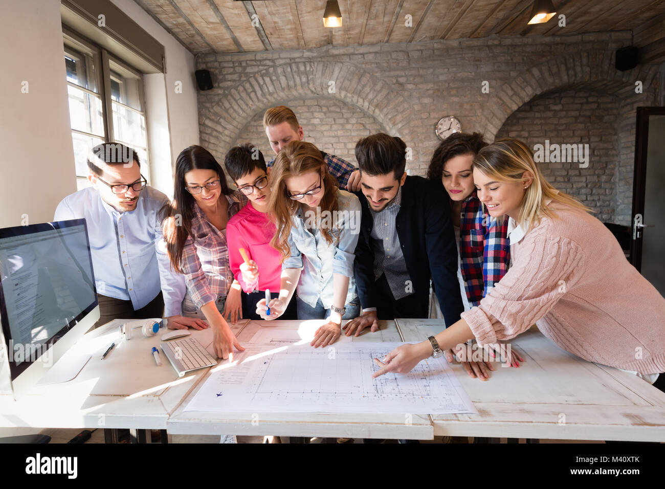 Picture of young architects discussing in office Stock Photo - Alamy