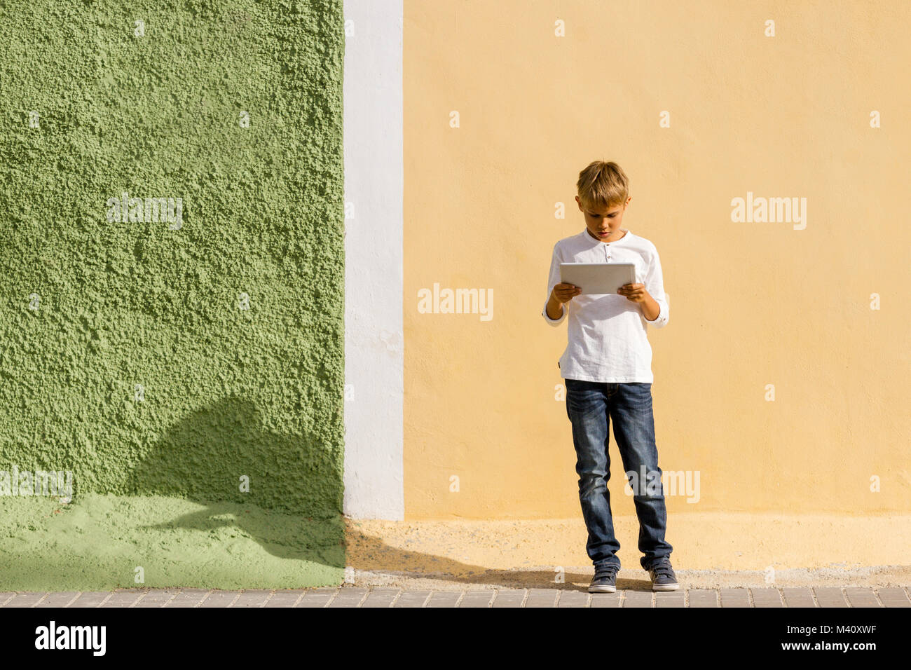 Child using tablet computer outdoors Stock Photo - Alamy