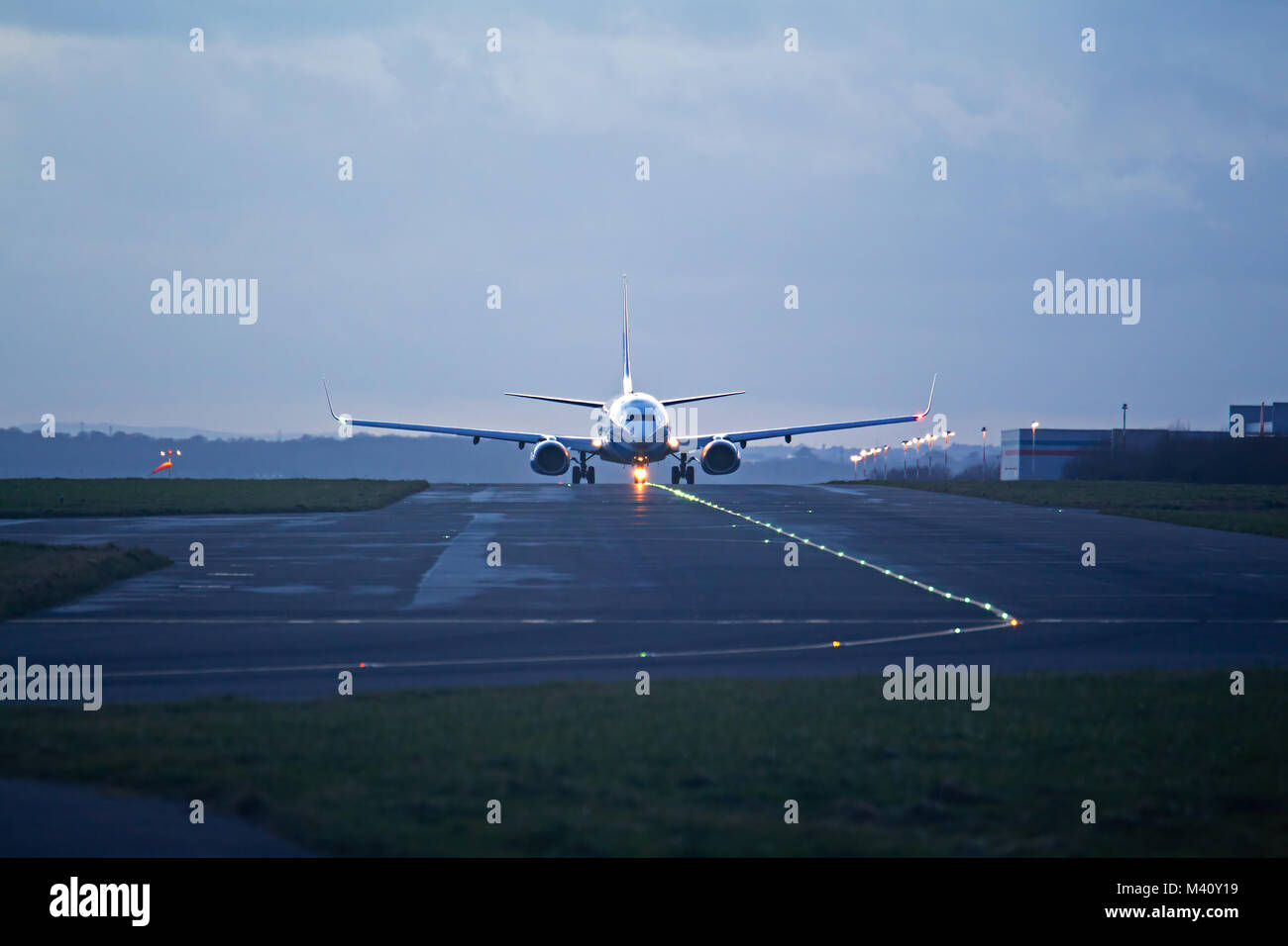 A passenger jet taxiing out to the runway for take off at Liverpool ...