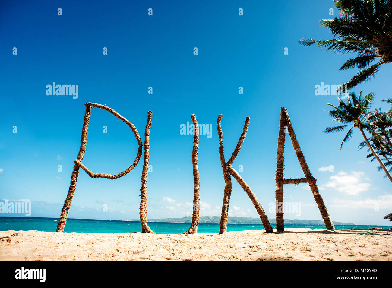 Puka Beach, Boracay, Philippines. Big wooden sign on the beach sand ...