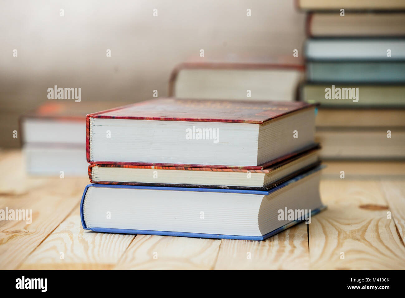 Textbooks and books on a wooden table. Book stack in the library room ...