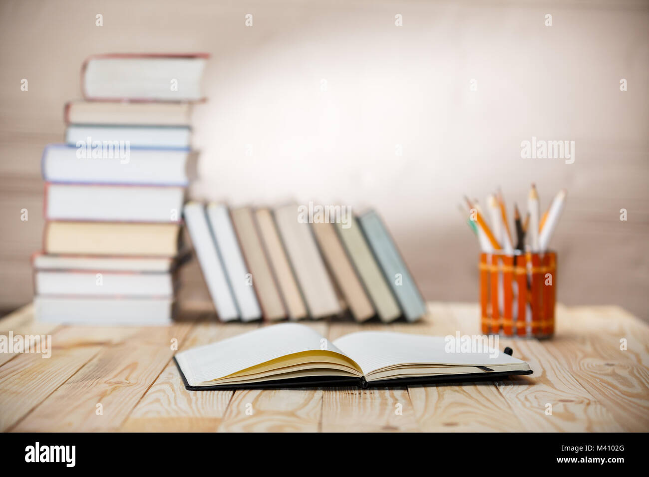 Open textbooks on wood desk with blurred focus for education background ...