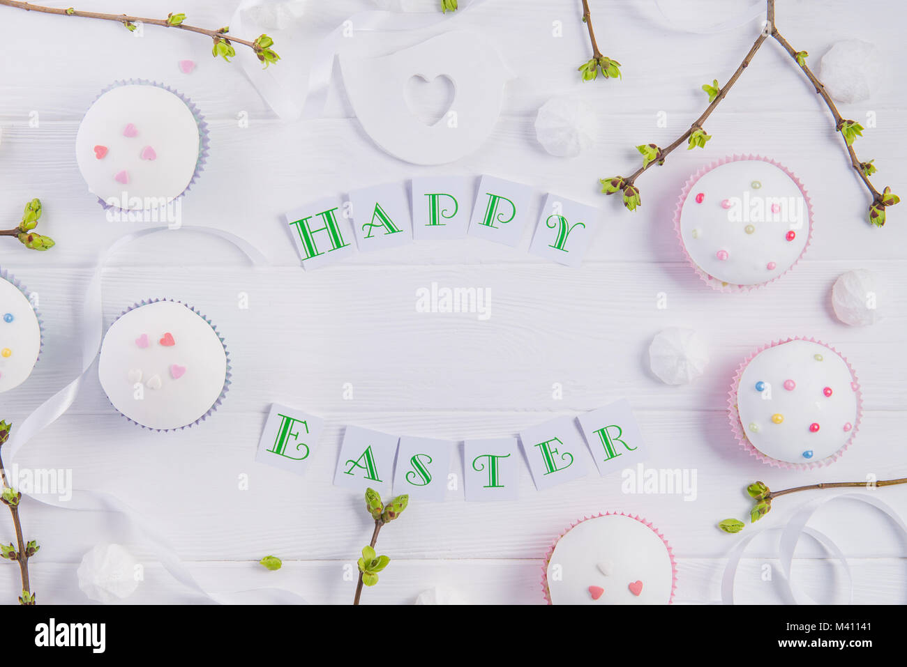 Top view holiday composition of Happy Easter lettering, branches with ...