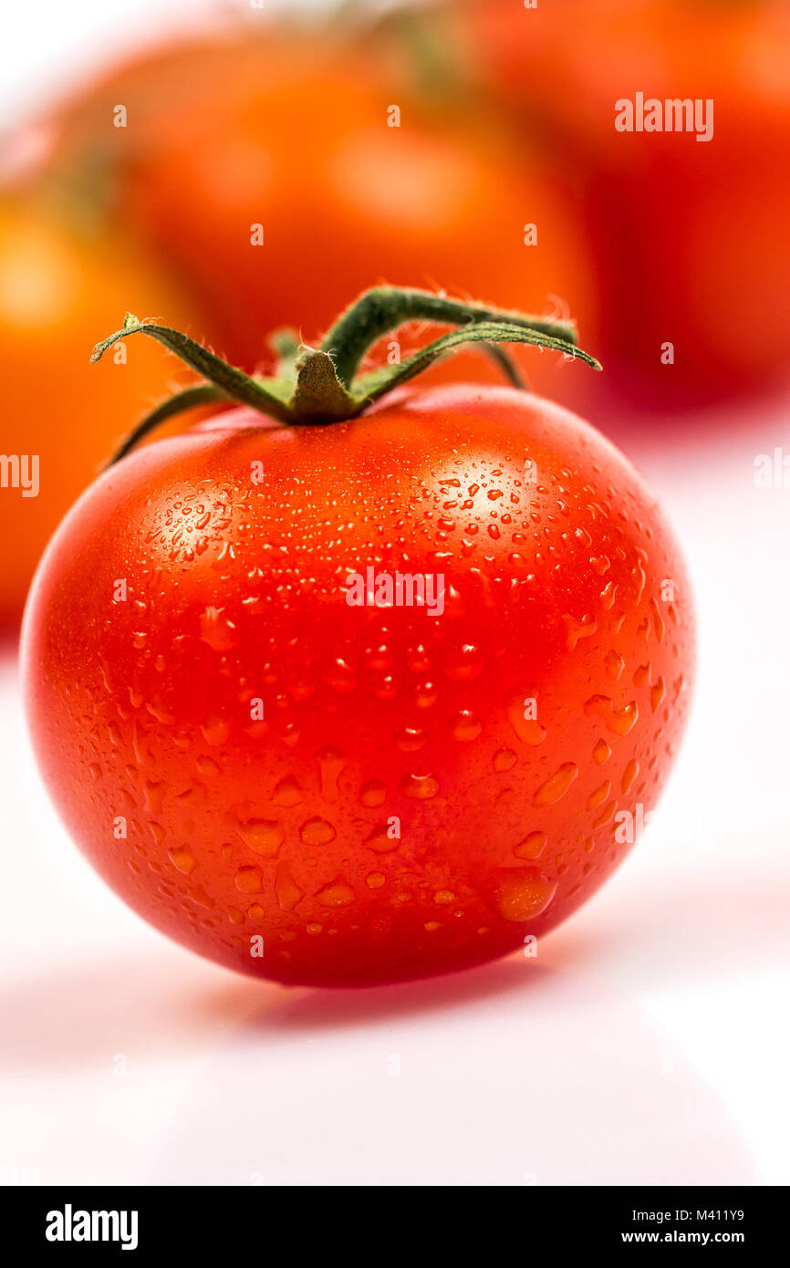 Tomato with water drops isolated on white background Stock Photo - Alamy