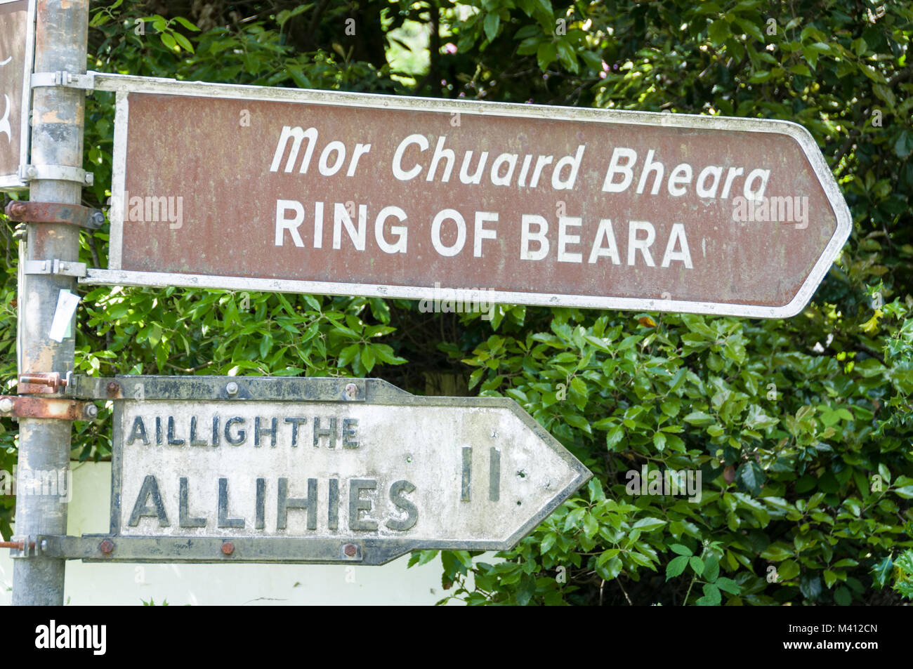 A Ring of Beara road sign and fading road sign on the Beara Peninsula ...
