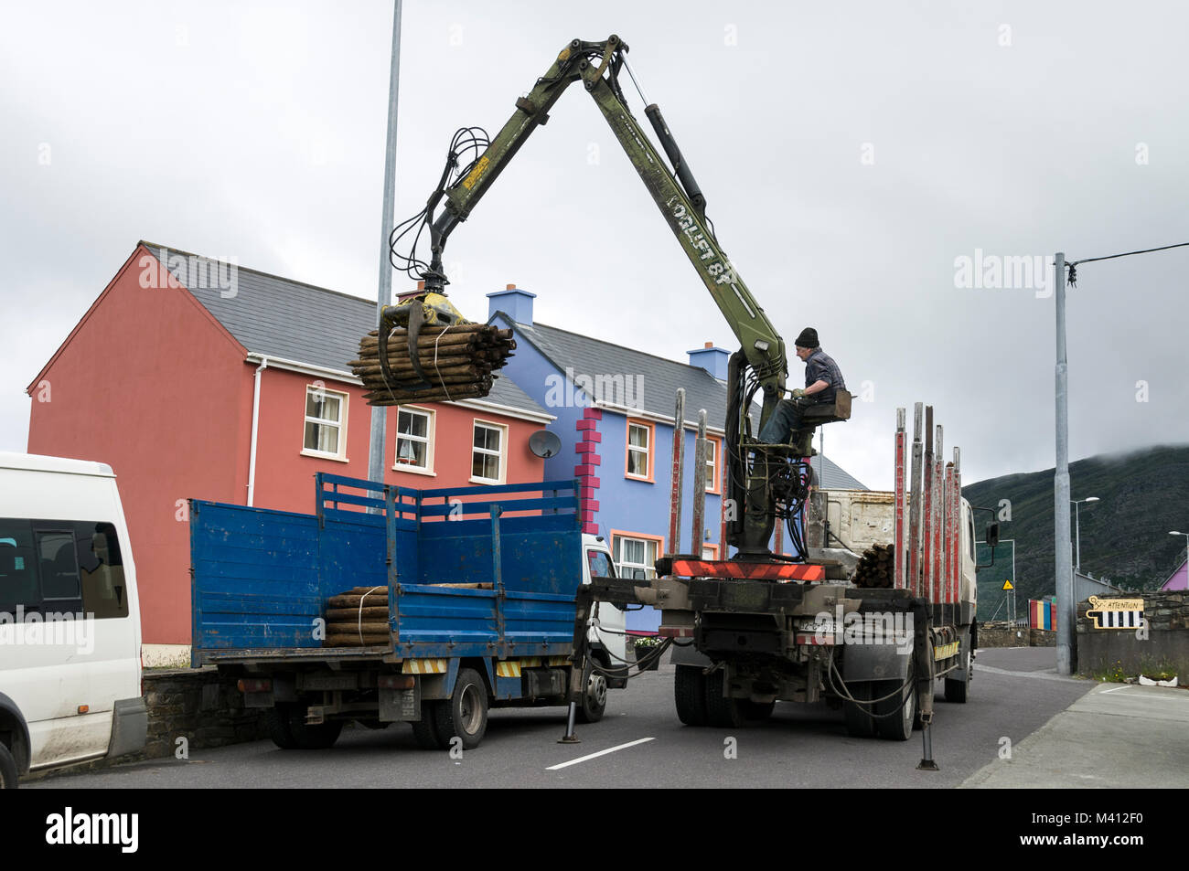 A lorry unloading fence poles onto a small pickup truck in Allihies on ...