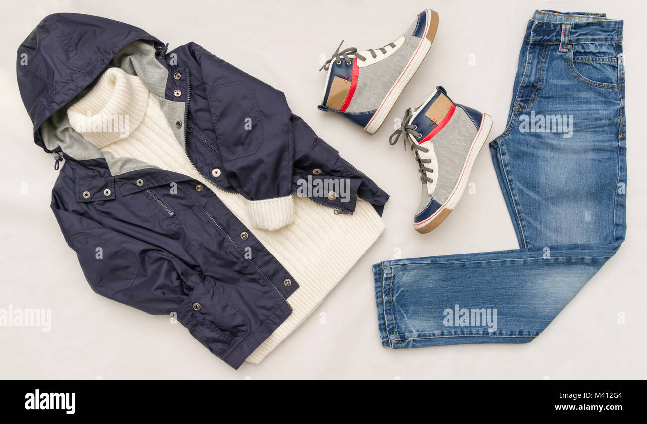Top view fashion trendy look of kids clothes on white wooden background ...