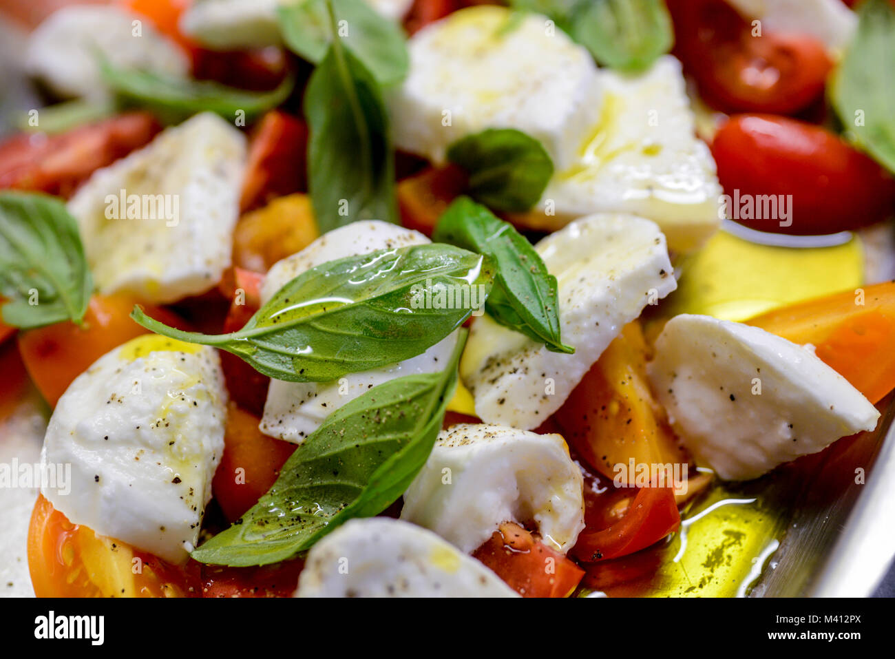 Italian Caprese salad with mozzarella cheese, tomatoes, sweet basil ...