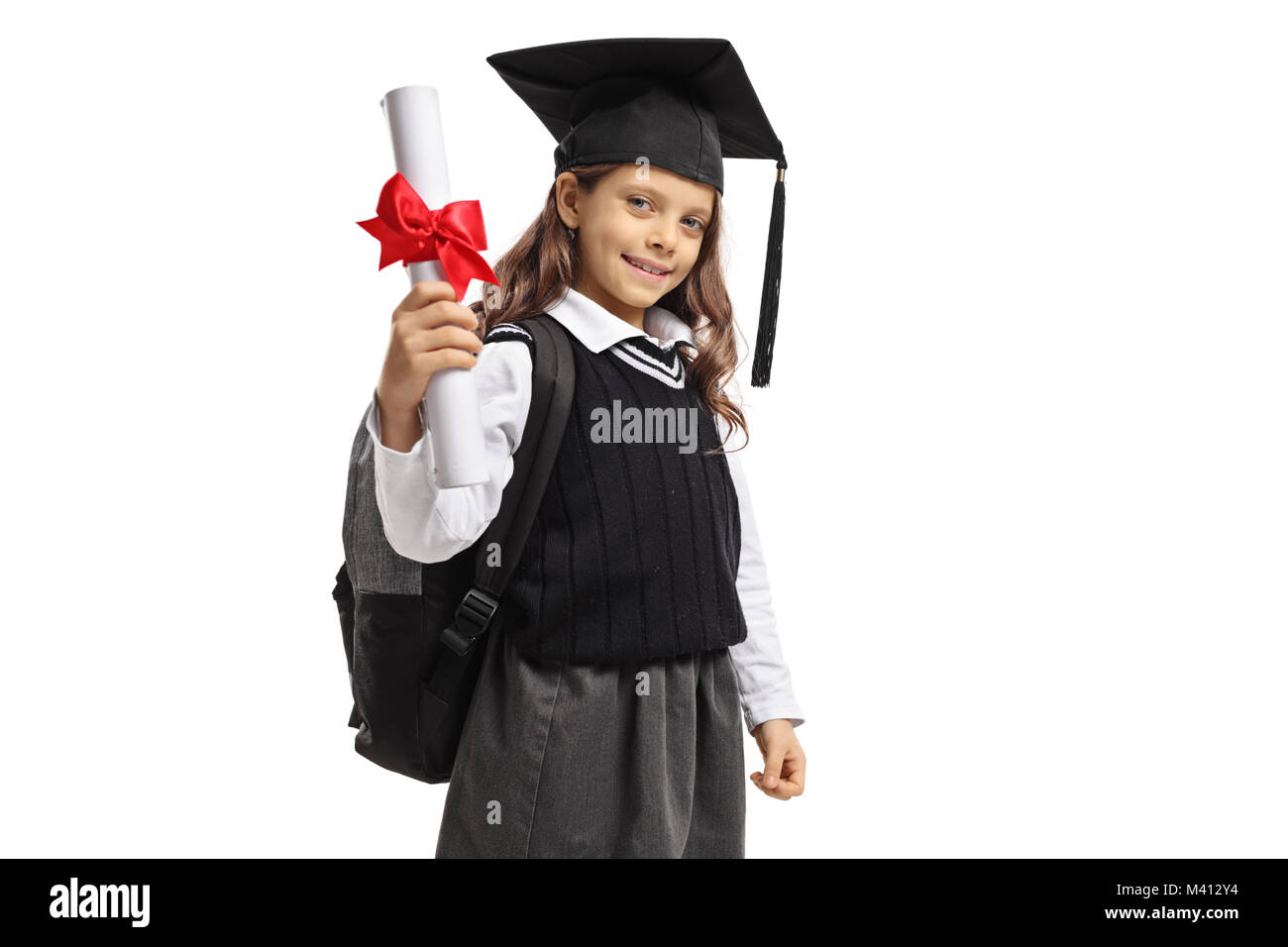 Little schoolgirl with a graduation hat and a diploma isolated on white ...