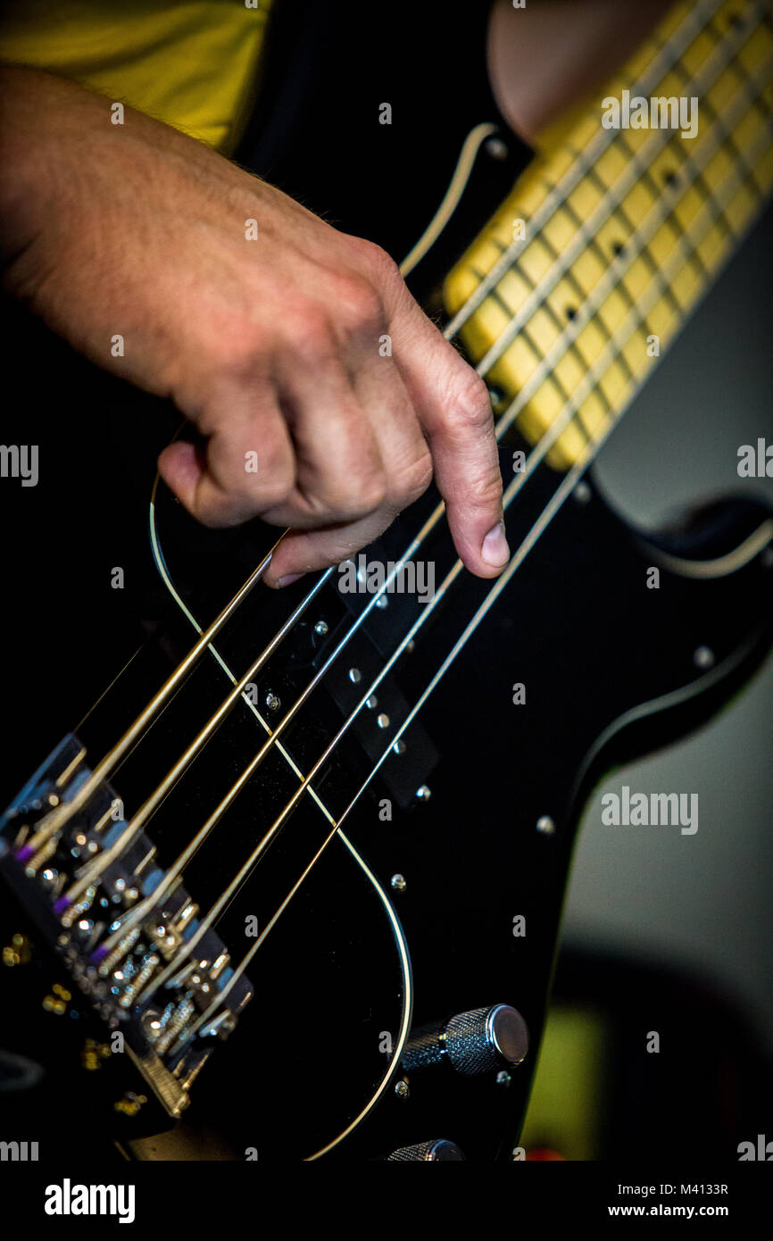 Bass guitar musician playing close up black Stock Photo - Alamy