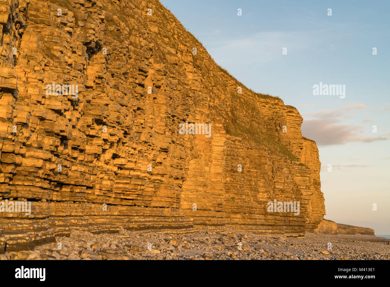 The stones and cliffs of Llantwit Major Beach in the evening sun, South ...
