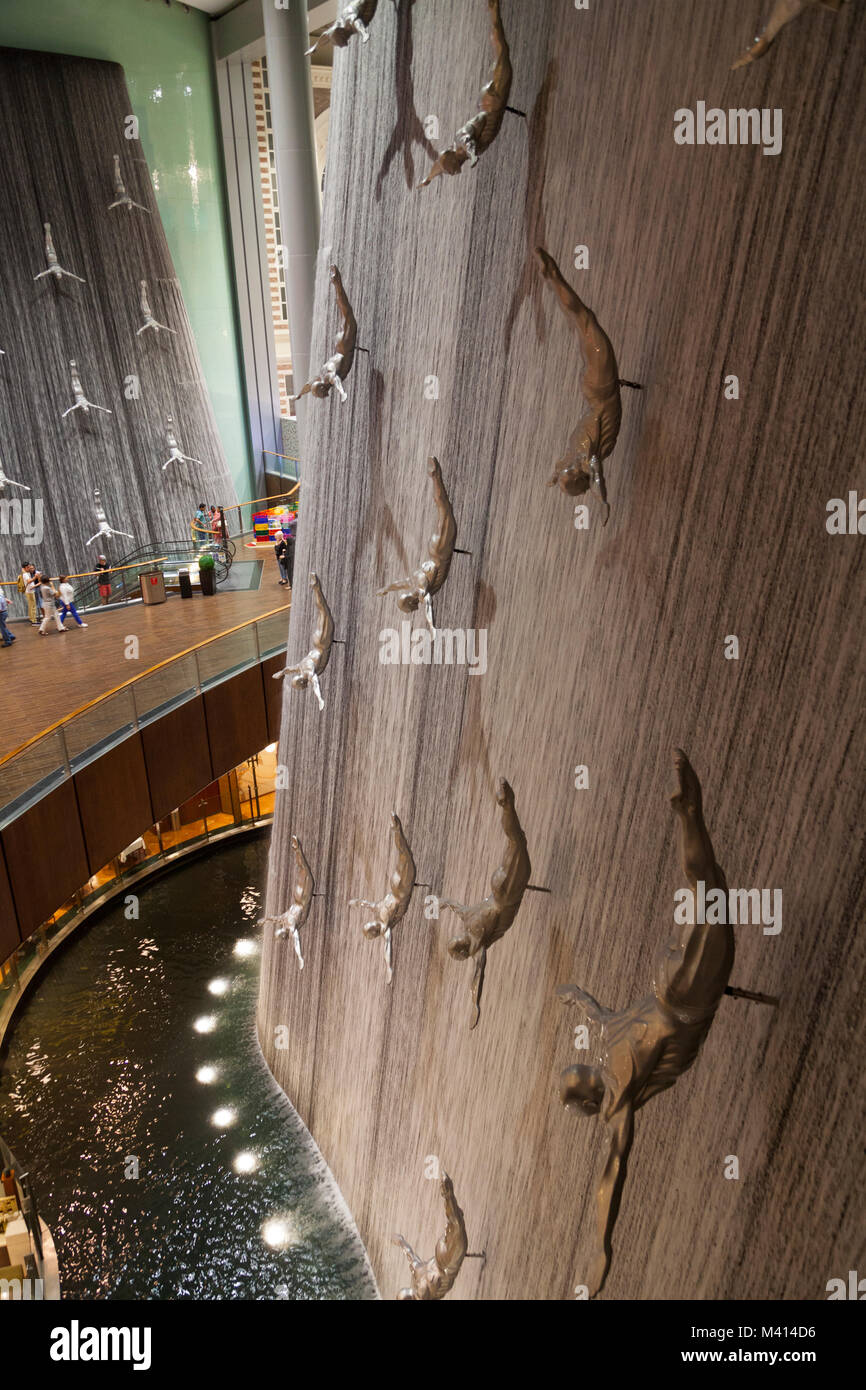 human waterfalls with statues of divers in the Dubai Mall in Dubai ...