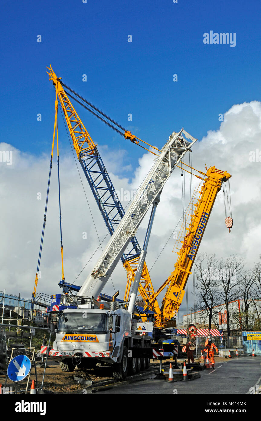 Mobile crane being used to erect larger mobile crane on site Stock ...