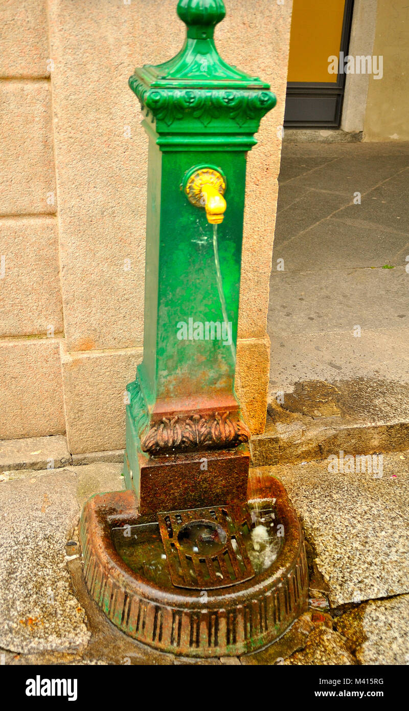 A traditional Italian water fountain with water blowing in the wind ...