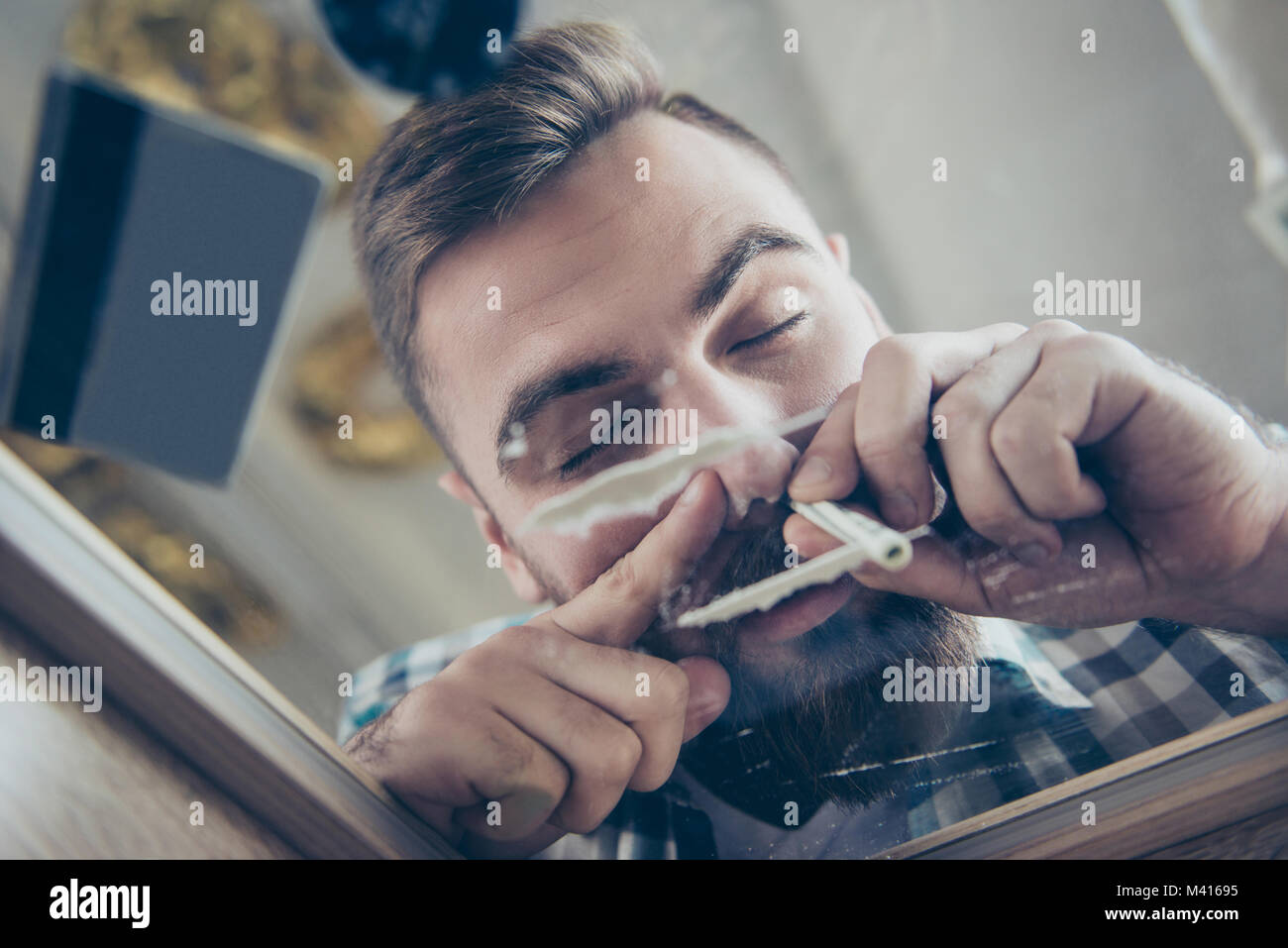 Close up man snorting drugs through rolled up hi-res stock photography ...
