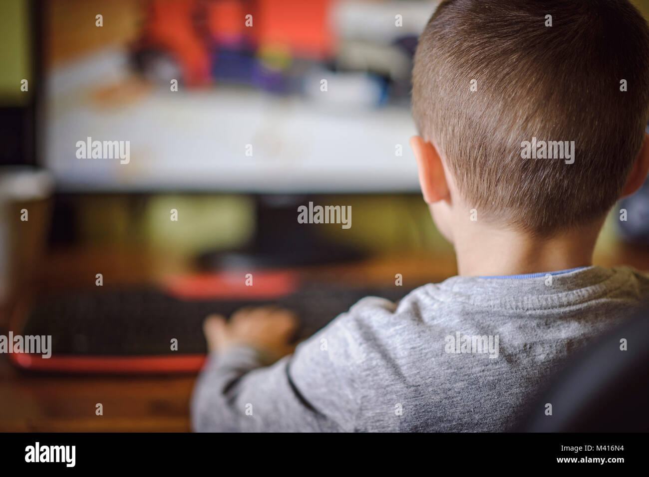 Young boy playing games on a desktop computer Stock Photo - Alamy