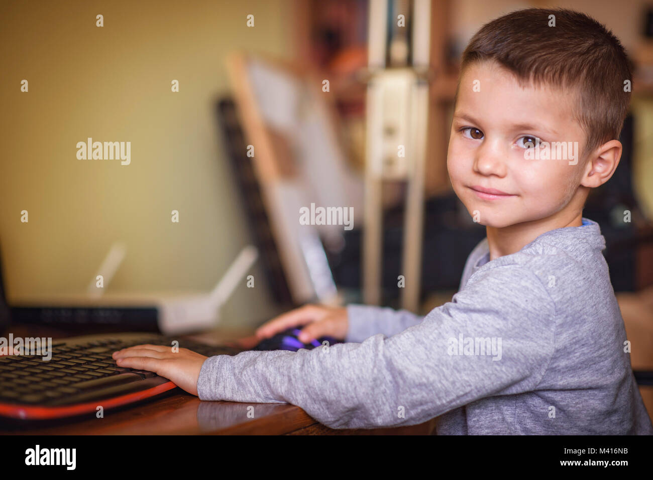 Young boy playing games on a desktop computer Stock Photo - Alamy