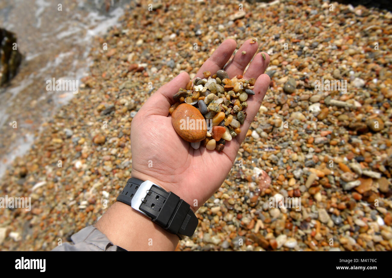 colorful tropical beach natural ocean gravel and sand rock in hand ...