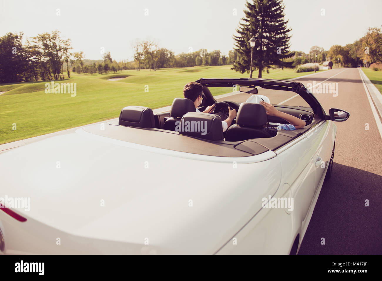 Back view cropped shot of driver and his lady in car. Happiness, dream ...