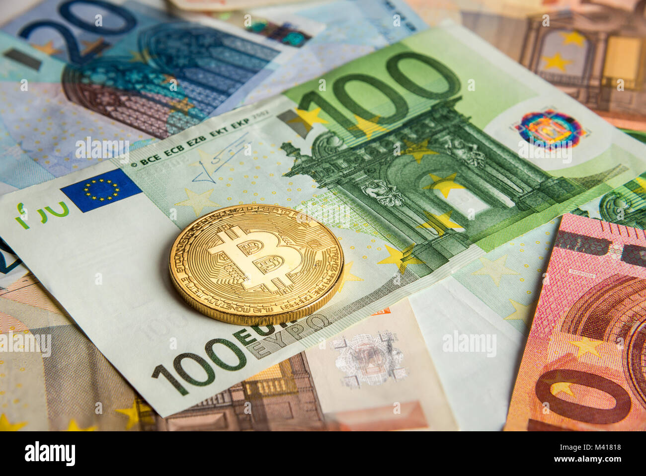 Bitcoin gold coin on euro banknotes Stock Photo - Alamy