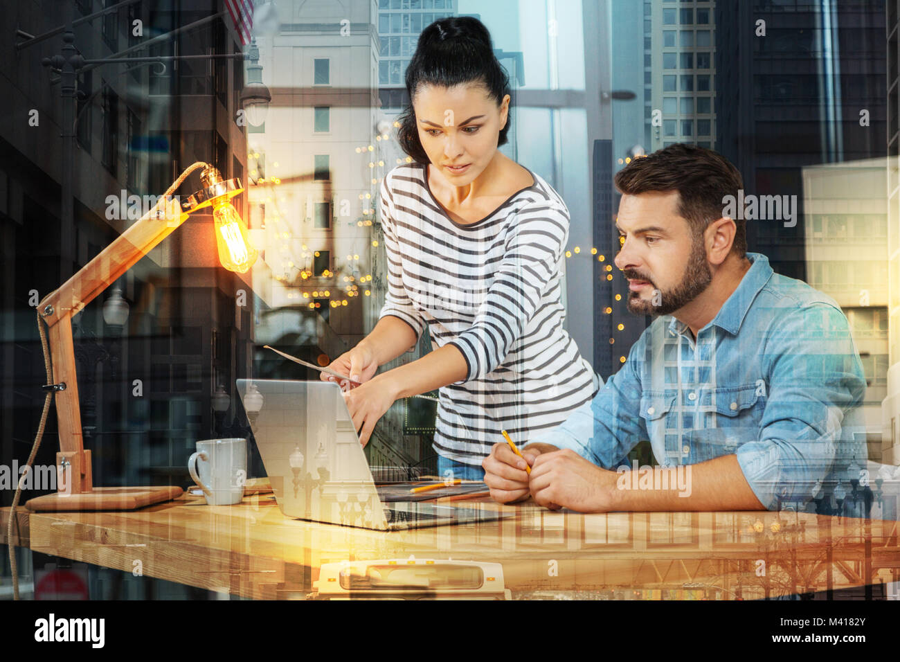 Enthusiastic woman asking questions while pointing to the screen Stock ...