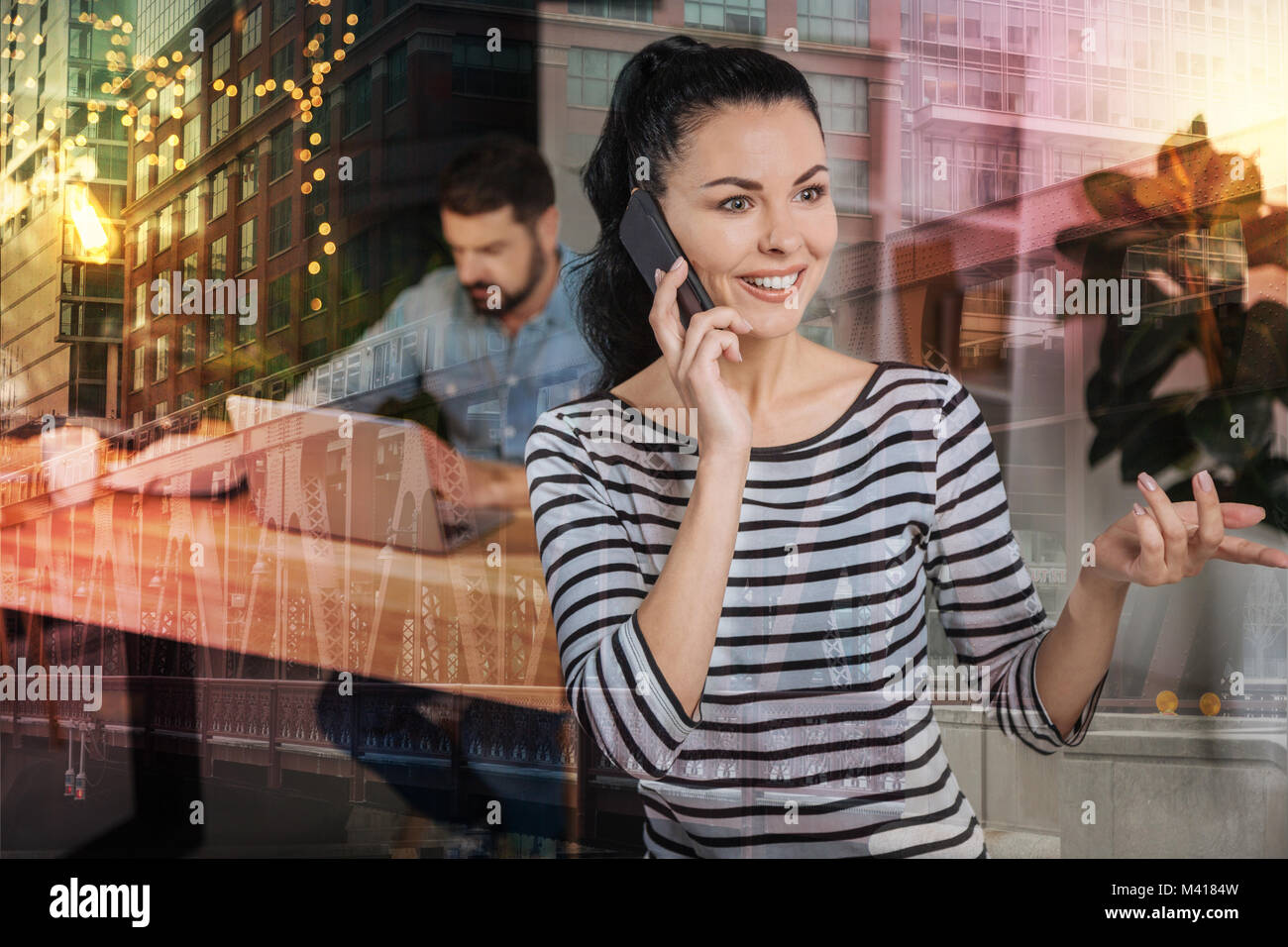 Excited woman feeling happy while talking on the phone Stock Photo - Alamy