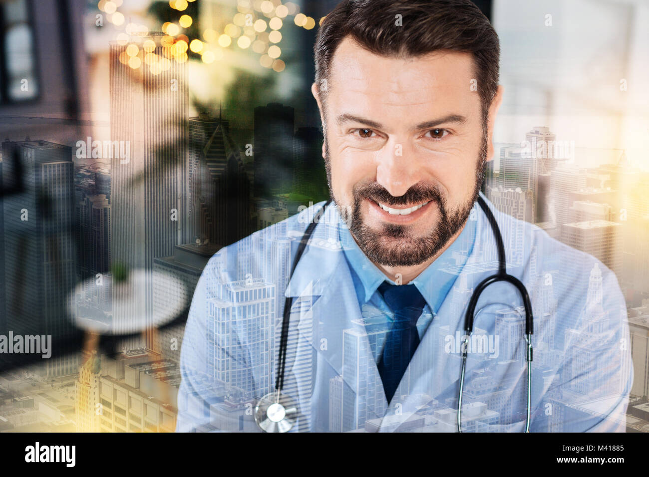 Happy emotional doctor smiling while being at work Stock Photo - Alamy