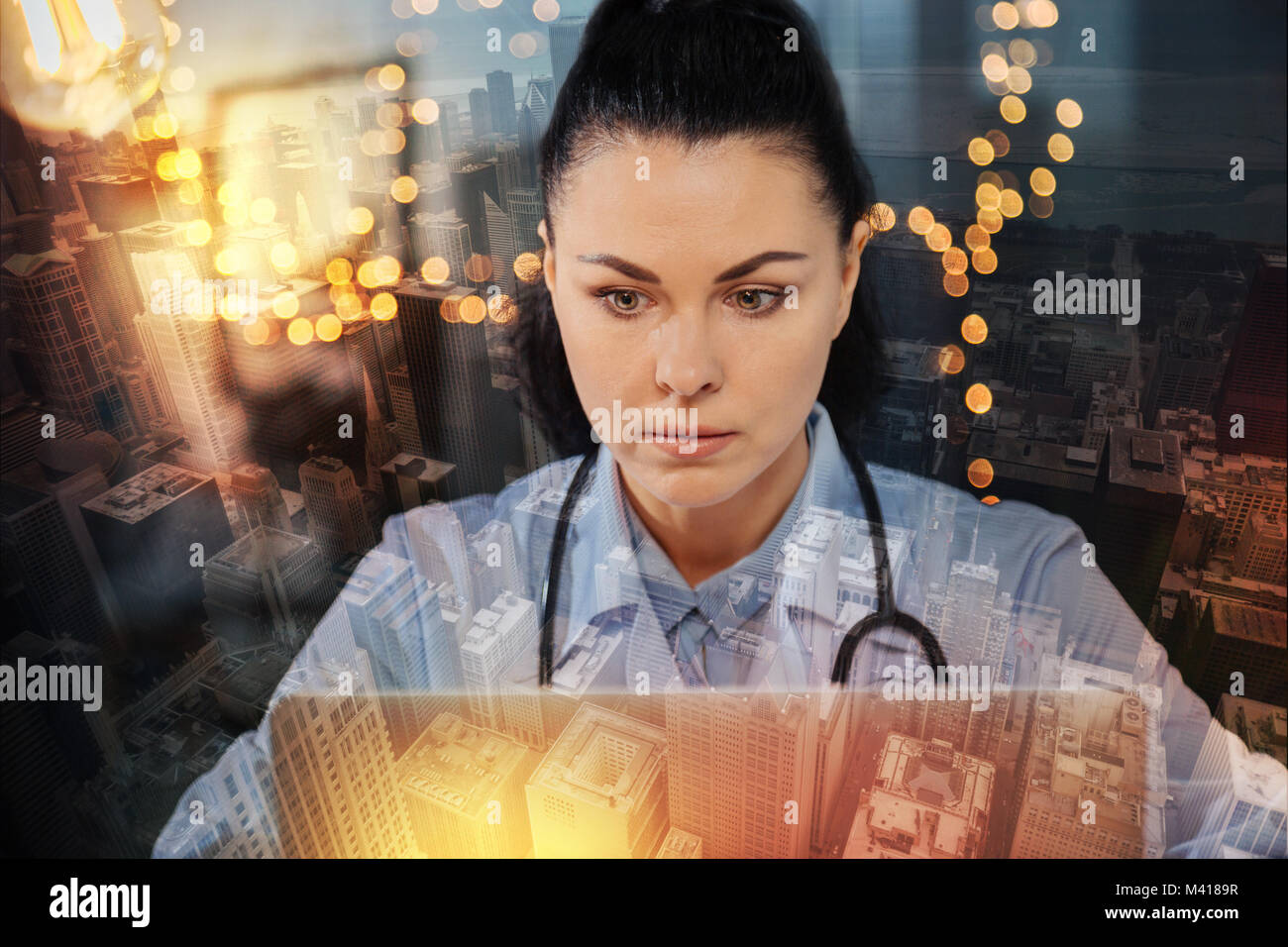 Busy doctor looking at the screen of her laptop while working alone ...