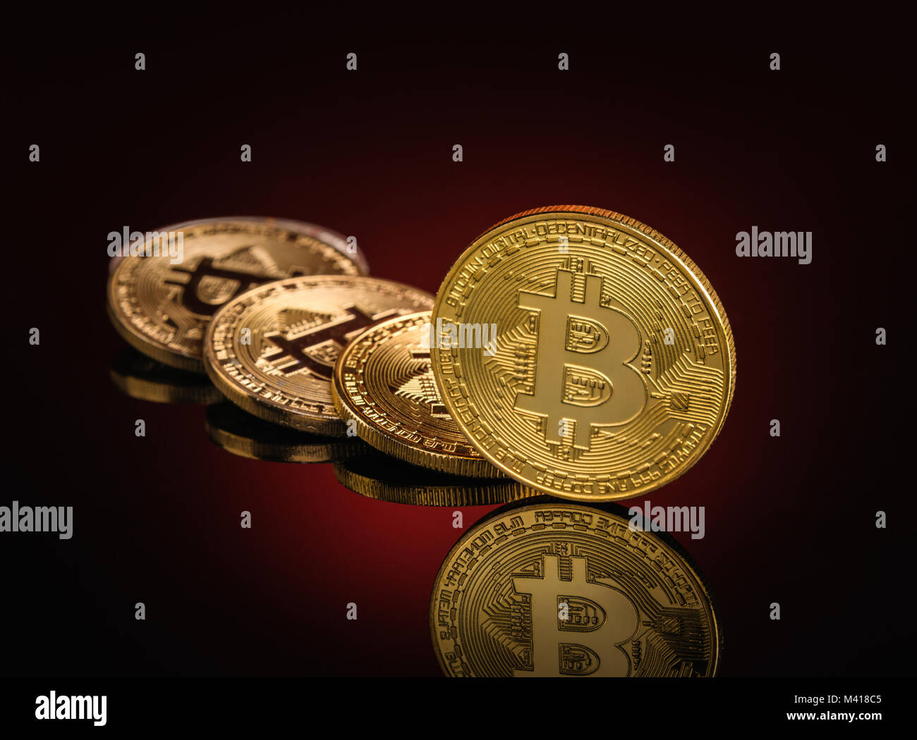 Bitcoins on dark red reflective background Stock Photo - Alamy
