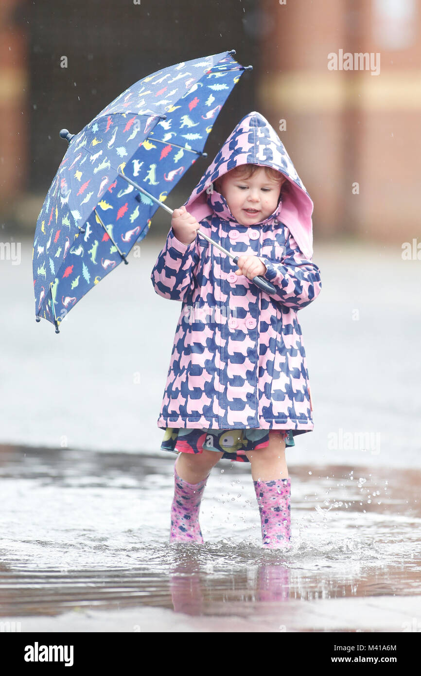 Ivy Mitchell splashes around in the rain after a heavy downpour in ...