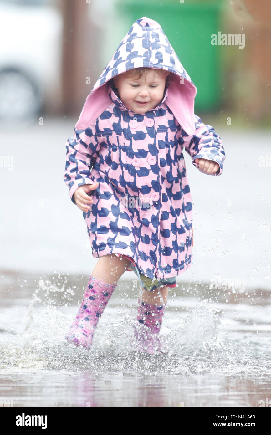 Ivy Mitchell splashes around in the rain after a heavy downpour in ...
