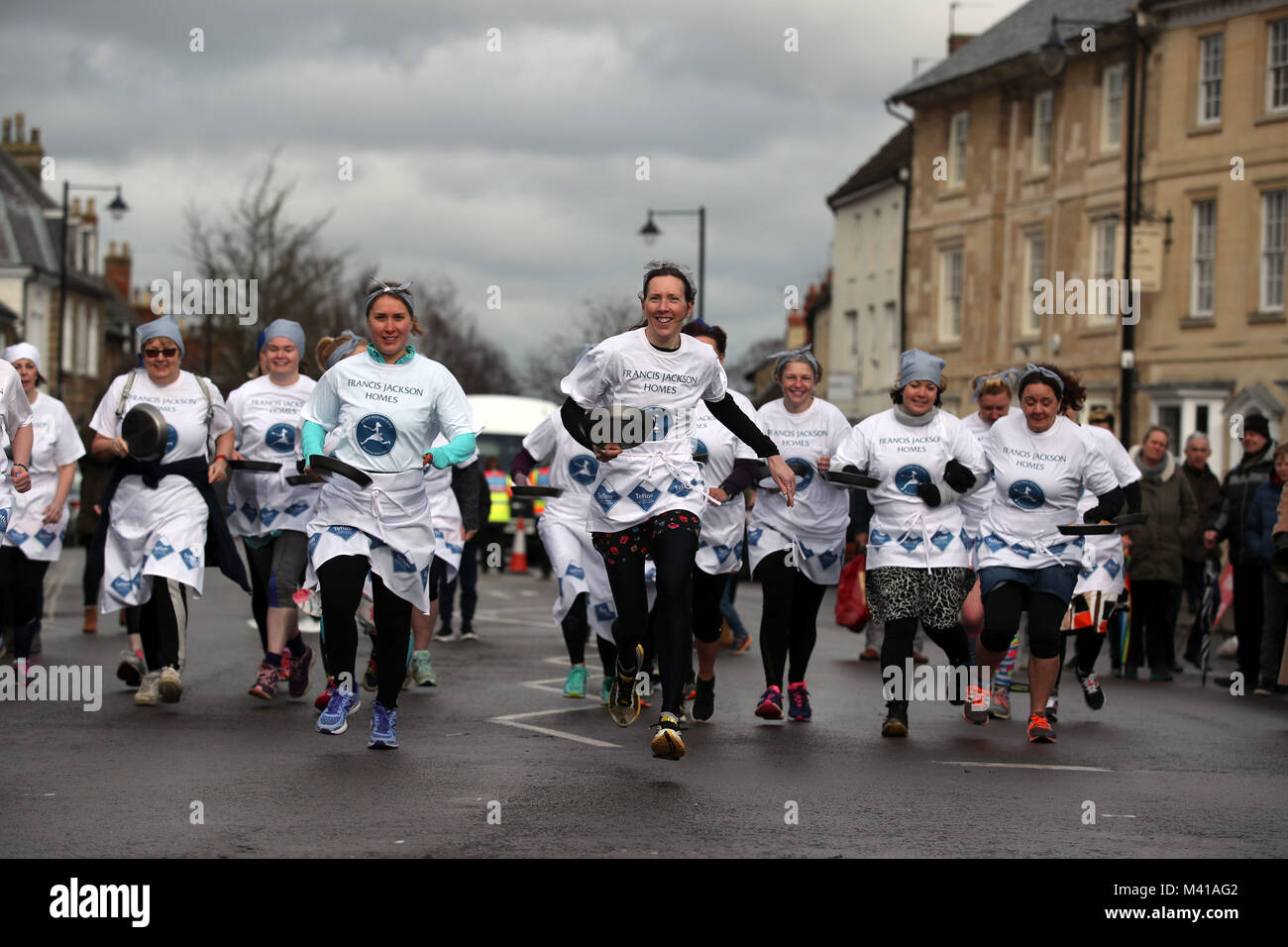 Participants take part in the annual Olney Pancake Race in Market Place ...