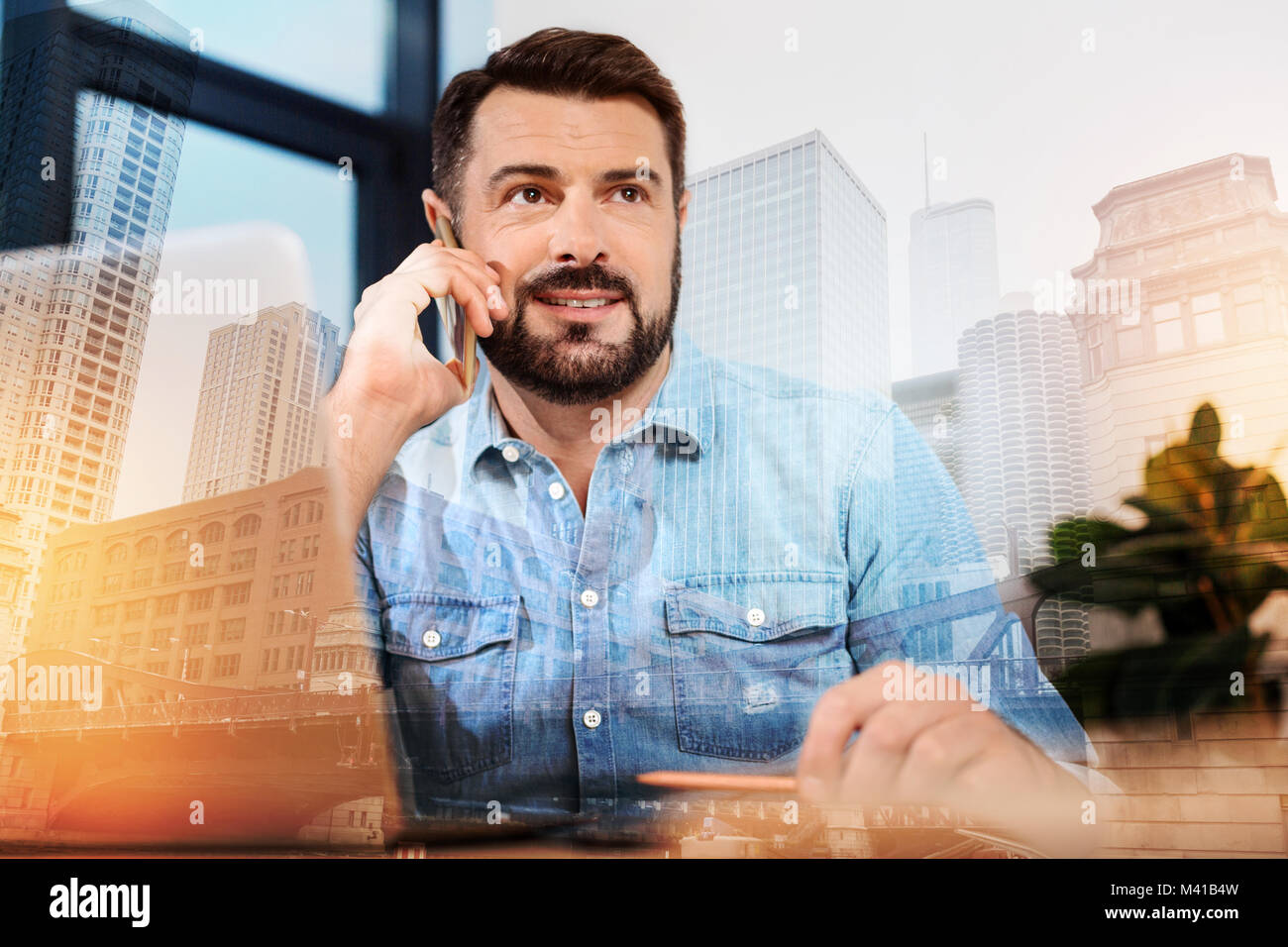 Friendly person looking positive while having a phone conversation ...