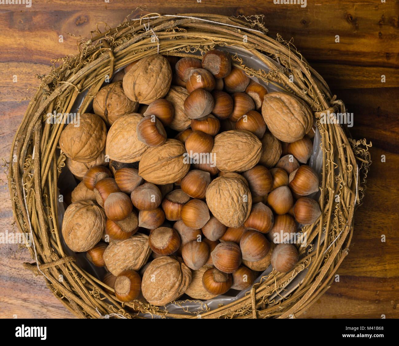 hazelnuts and walnuts background in straw basket Stock Photo - Alamy