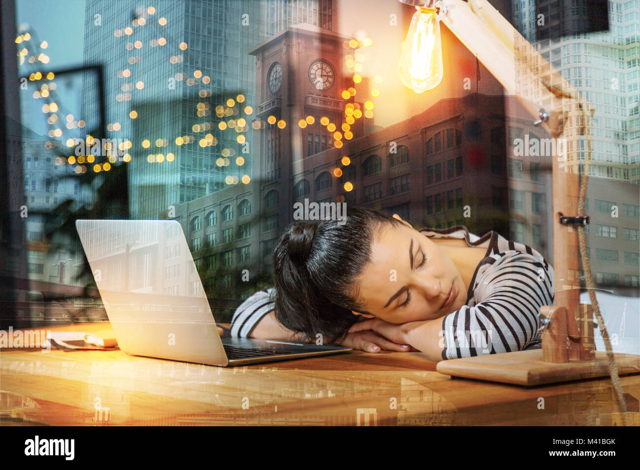Tired young woman sleeping while sitting at the table Stock Photo - Alamy