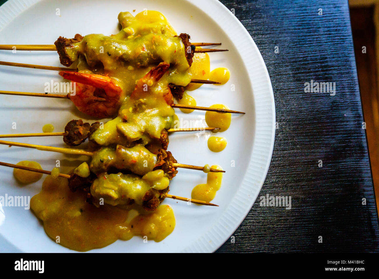Satay, sate, or satti, is a dish of seasoned, skewered and grilled meat ...