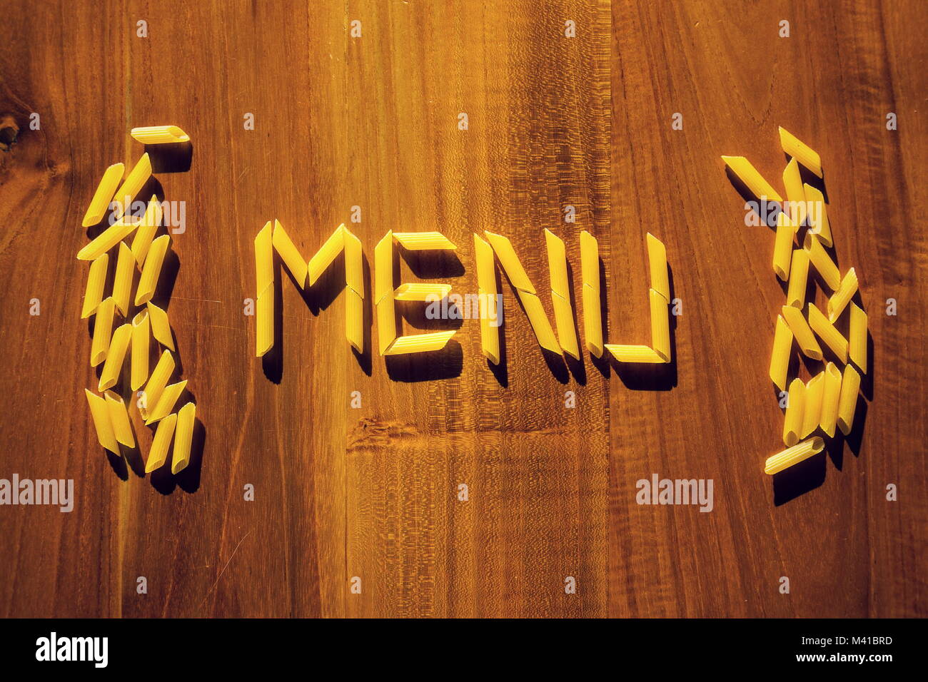 Menu letters from penne pasta on wooden table, cooking restaurant Stock ...