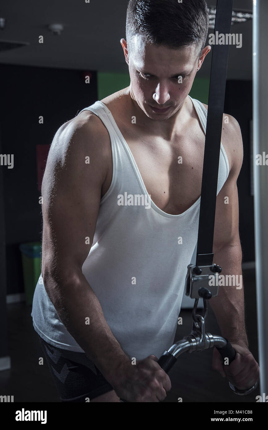 Man doing cable fly exercise in gym Stock Photo - Alamy