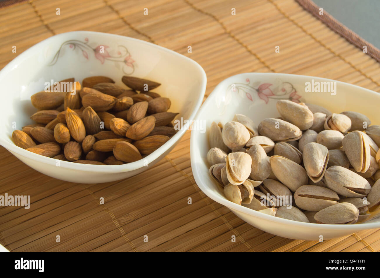 Two bowls of almonds and pistachios. Healthy meals snacks Stock Photo ...
