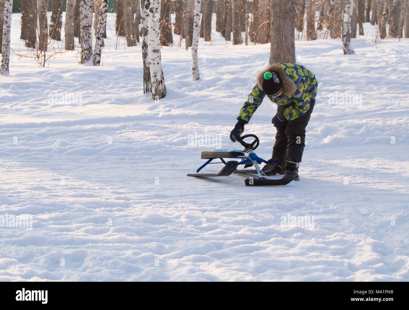 Baby boy, check the snowmobile, rolled down from the hill Stock Photo ...