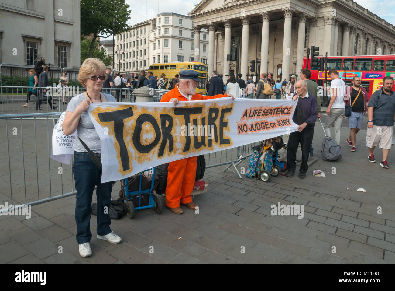 People hold a banner 'Torture - a ilfe sentence No Judge or Jury' at ...